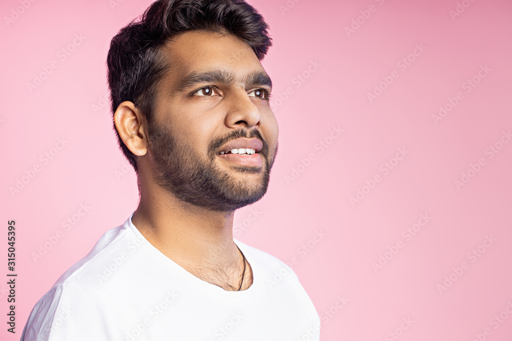 Portrait of handsome Indian guy standing on pink background Stock Photo ...