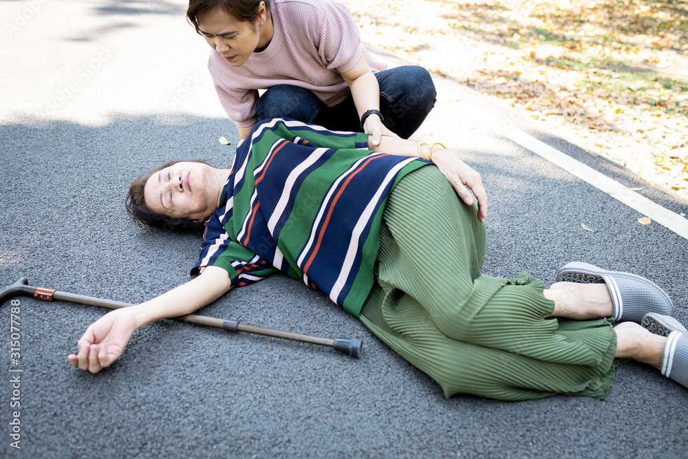 Sick asian senior woman or mother is fainted and fallen on floor ...