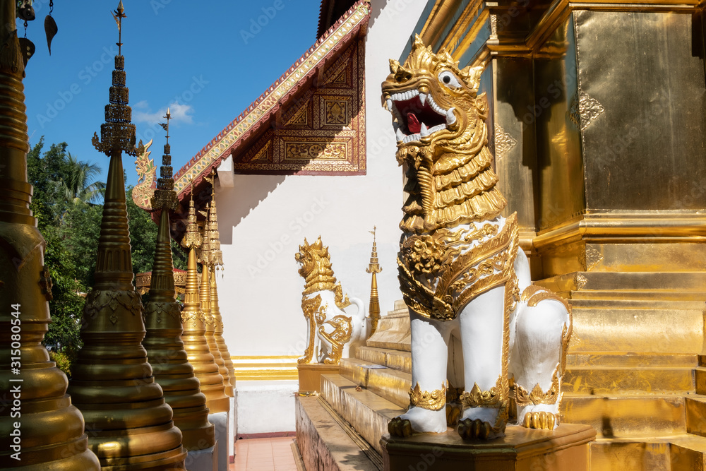 The lion statue decorated at the base of Sinhalese style pagoda that ...