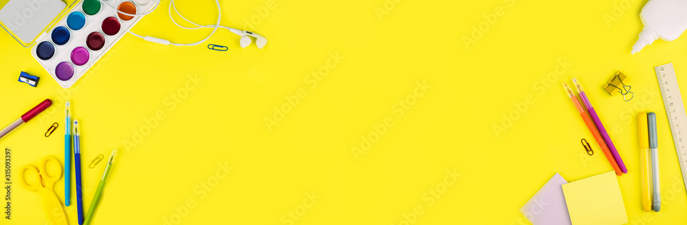 Banner made from different school supplies on bright yellow paper ...