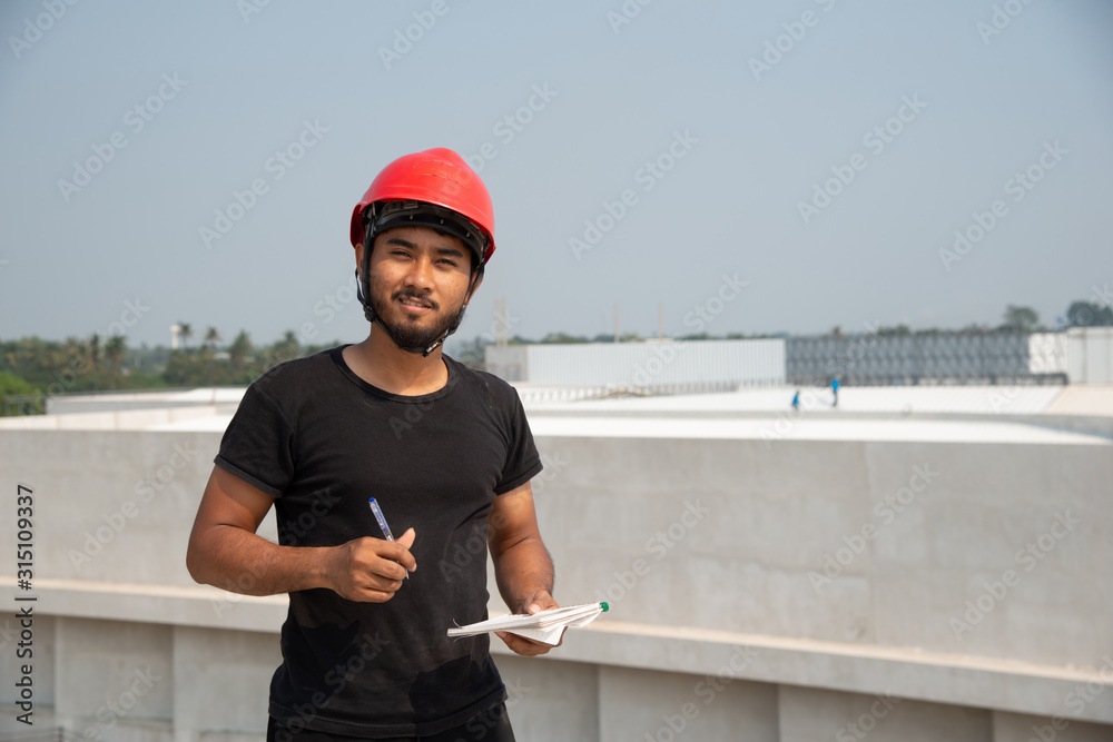 Black bearded engineer wear red hard hat and black working suit make ...