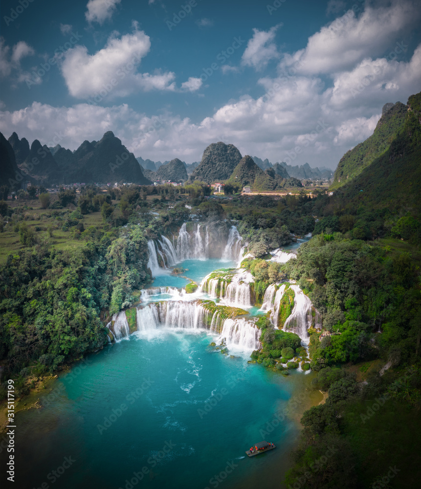 Massive hidden waterfall surrounded by mountain with blue clean water ...