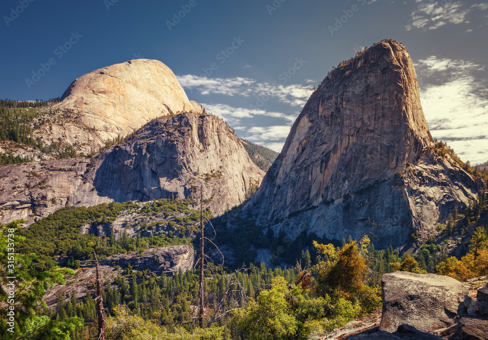 Impressive granite faces of Liberty Cap and Half Dome tower over the ...