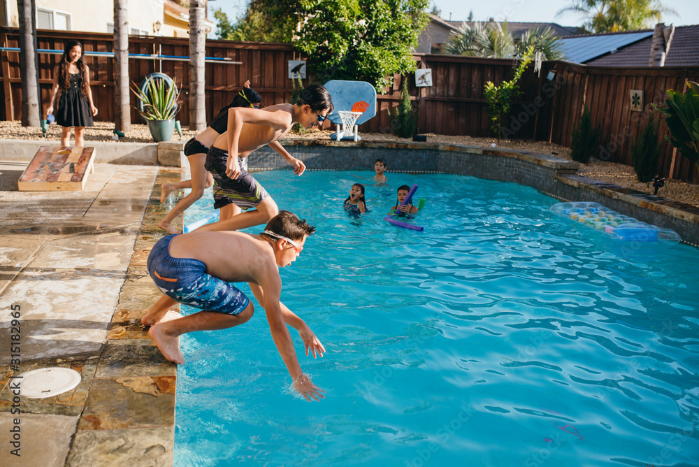 Happy children jumping in swimming pool Stock Photo | Adobe Stock