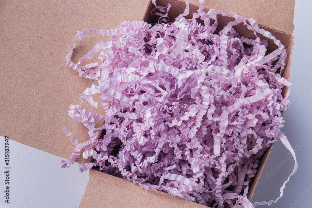 Pink shredded paper stuffing cardboard box. Top view, close-up. Stock ...