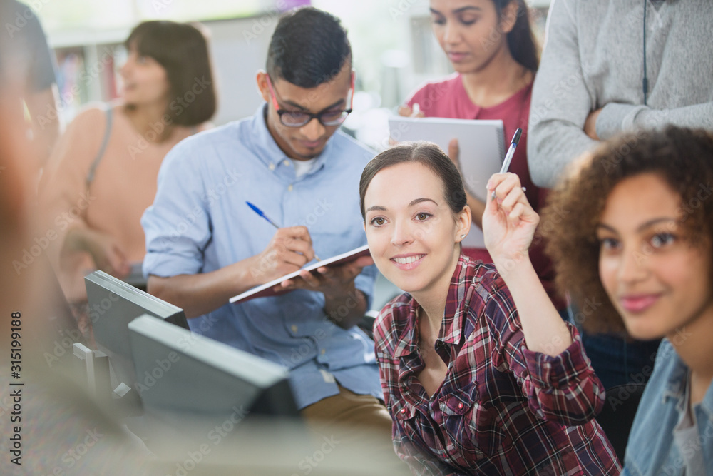 College student raising hand in computer lab classroom Stock Photo ...