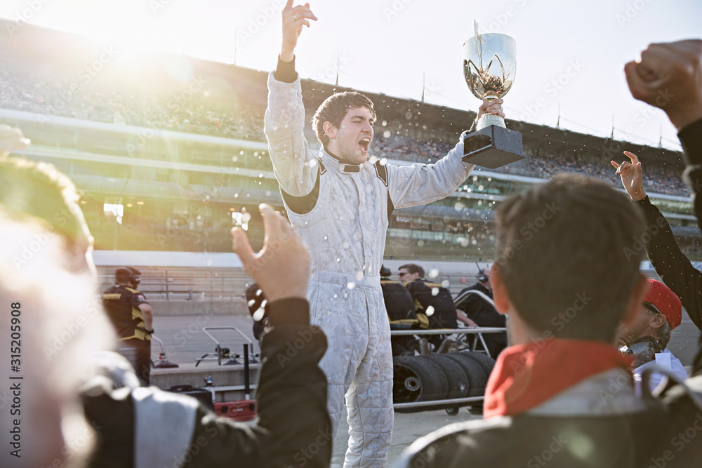 Formula one racing team cheering for driver trophy, celebrating victory ...