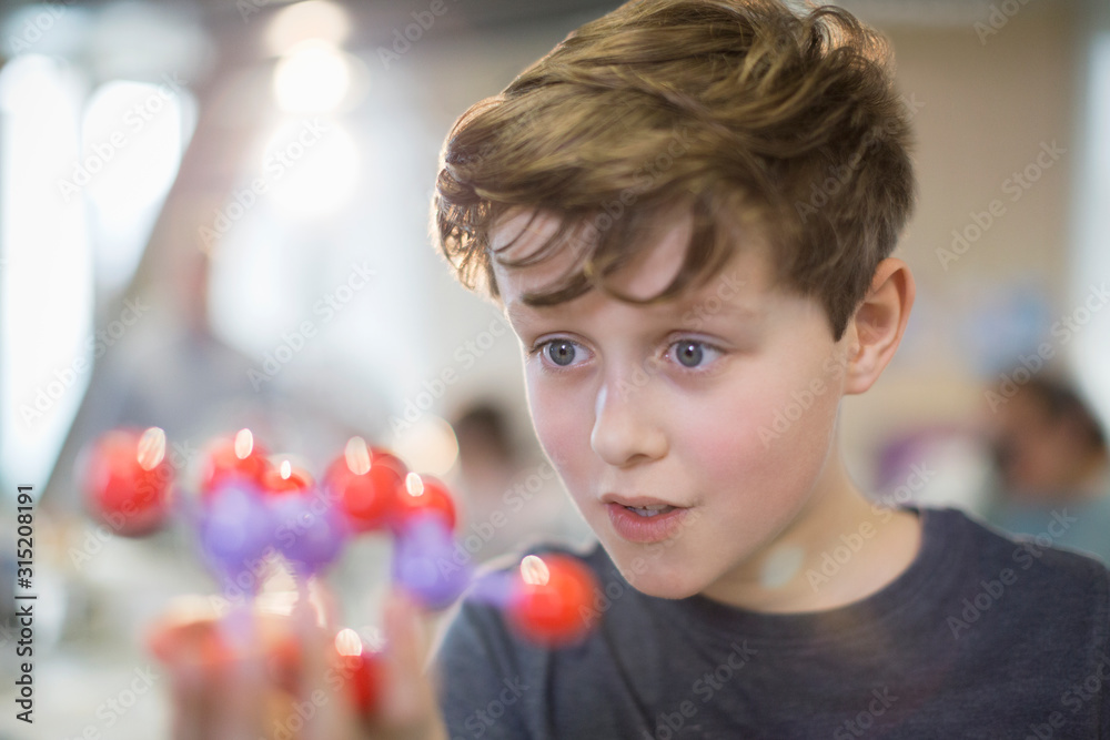 Curious boy examining molecule model in laboratory classroom Stock ...