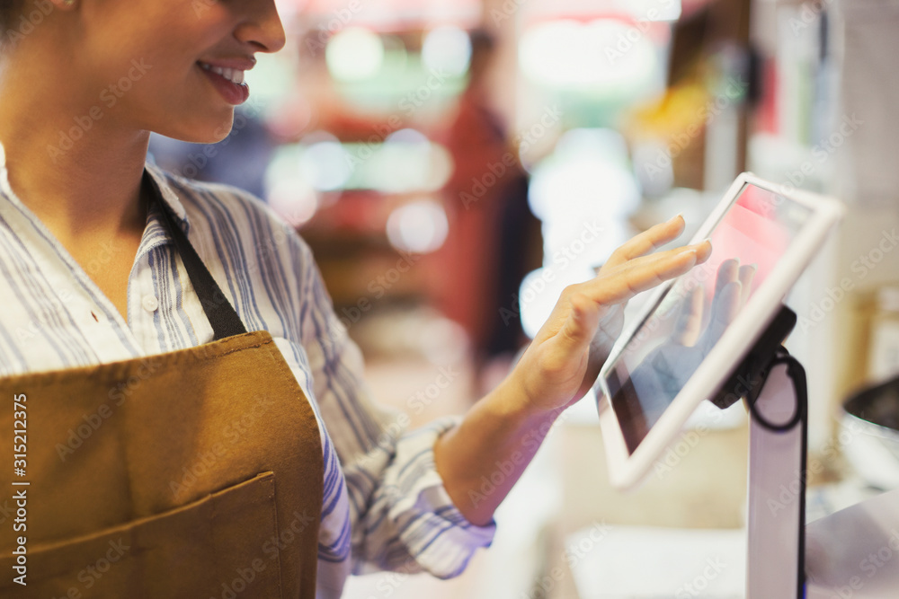 Female cashier using touch screen cash register in grocery store Stock ...