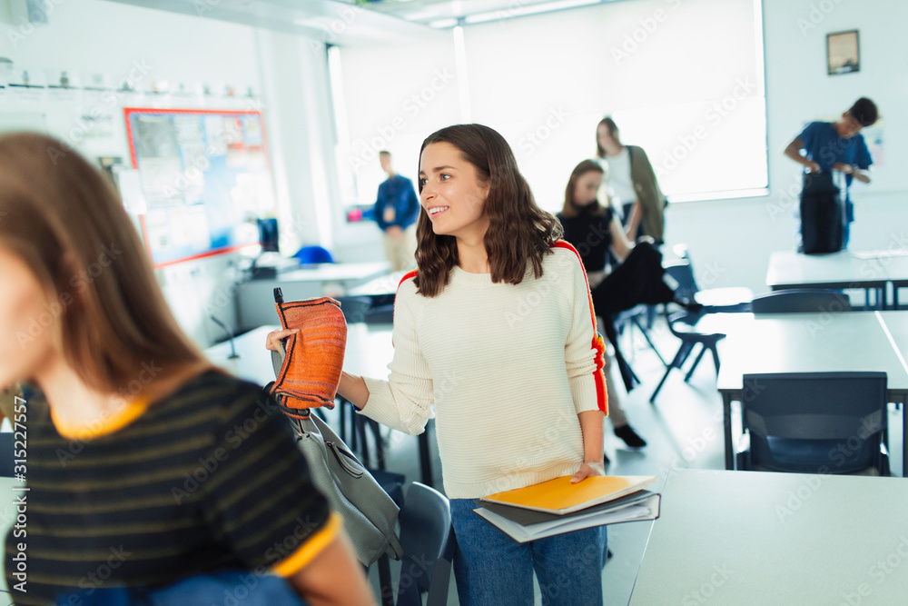 Smiling high school girl student leaving classroom Stock Photo | Adobe ...