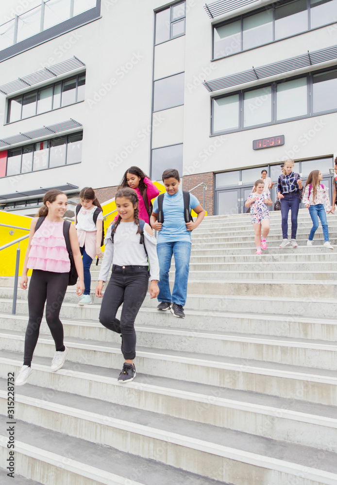 Junior high students leaving school building, descending steps Stock ...