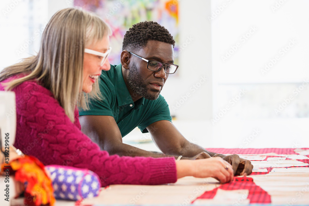 Fashion designers assembling sewing pattern Stock Photo | Adobe Stock