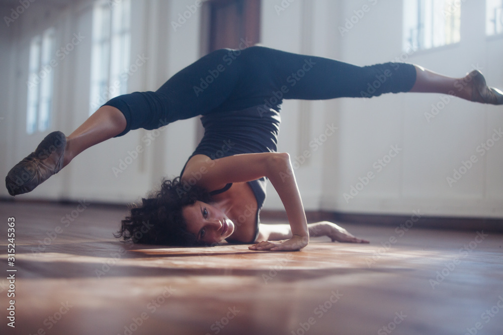 Strong young female dancer practicing in dance studio Stock Photo ...