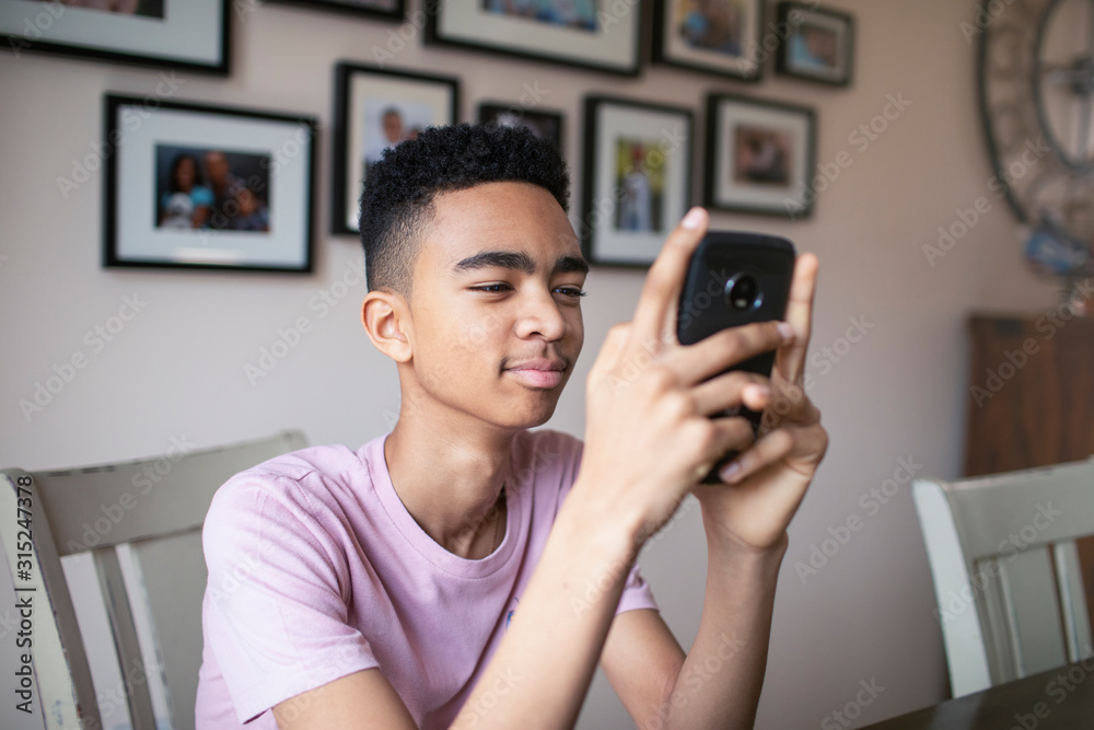 Teenage boy using smart phone Stock Photo | Adobe Stock