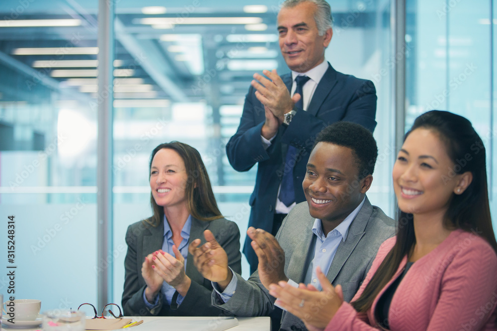 Business people smiling and clapping in conference room meeting Stock ...