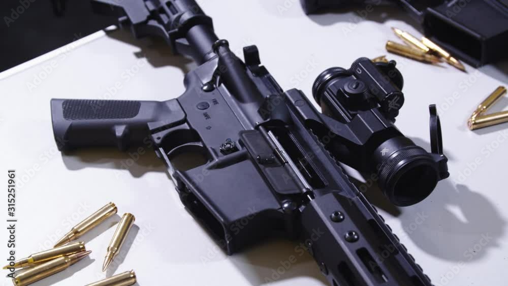 Tabletop of an unloaded semi-automatic weapon, with brass bullets ...