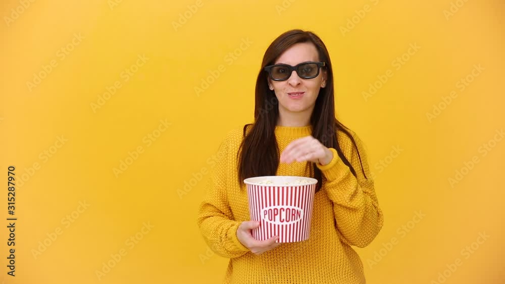 Fun young woman in 3d imax glasses watching movie film, holding bucket ...