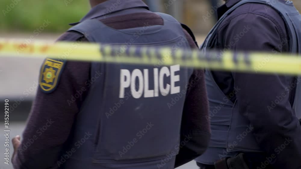 Policeman in full police uniform guard a crime scene. South Africa ...