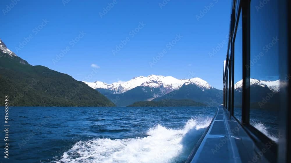 Sailing boat on the lake with a view to a beautiful massive mountain ...