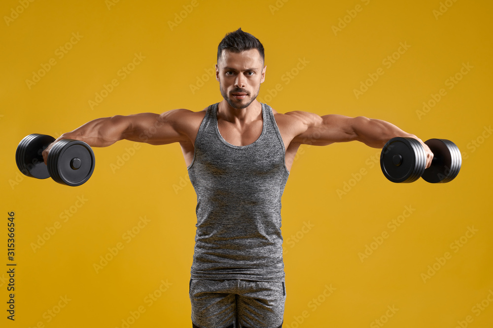 Strong bodybuilder training with dumbbells Stock Photo | Adobe Stock