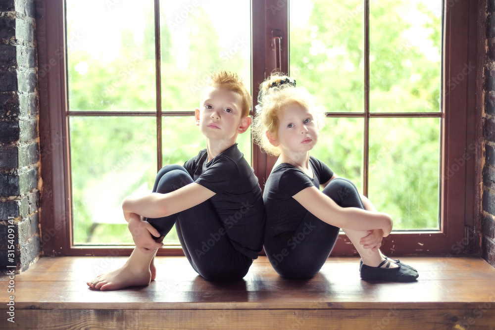 Portrait of 2 little children dancer girl and boy in black leotard ...