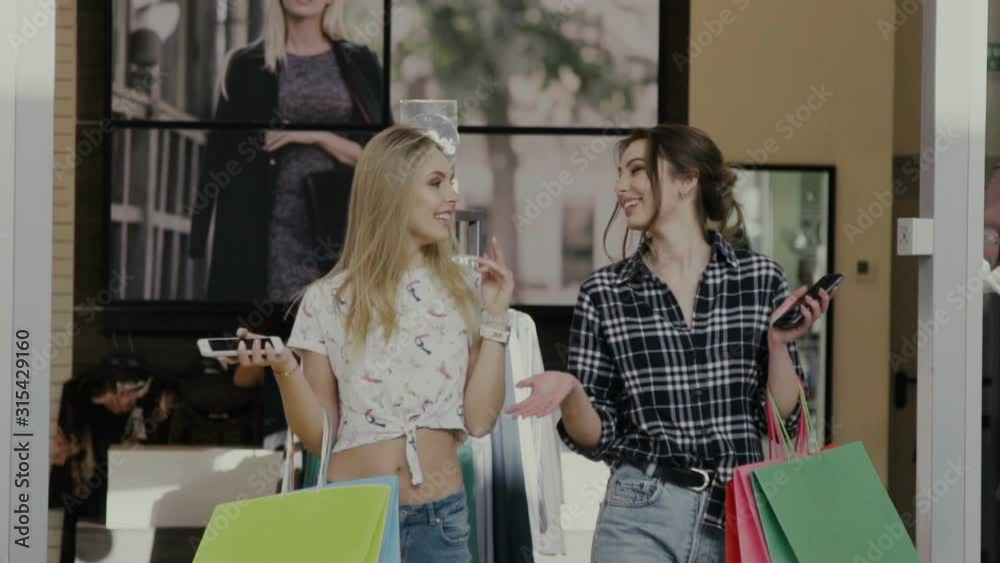 pretty girl laughing and talking affter shopping Stock ビデオ | Adobe Stock