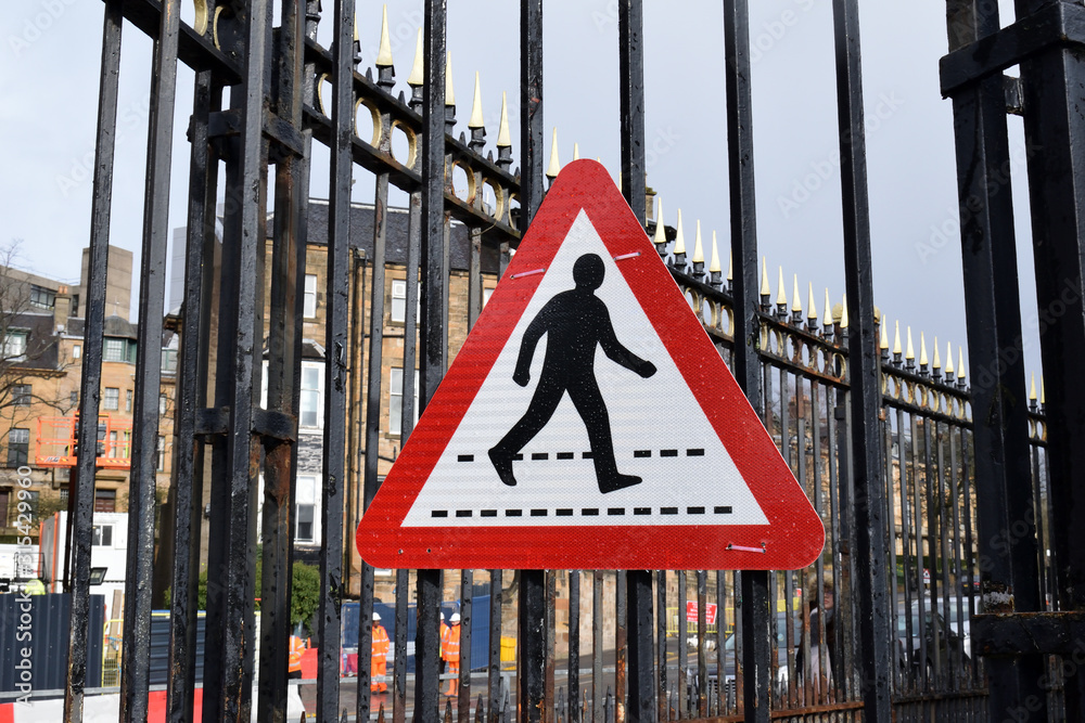 Metal Pedestrian Warning Sign Attached toto Vertical Iron Railings ...