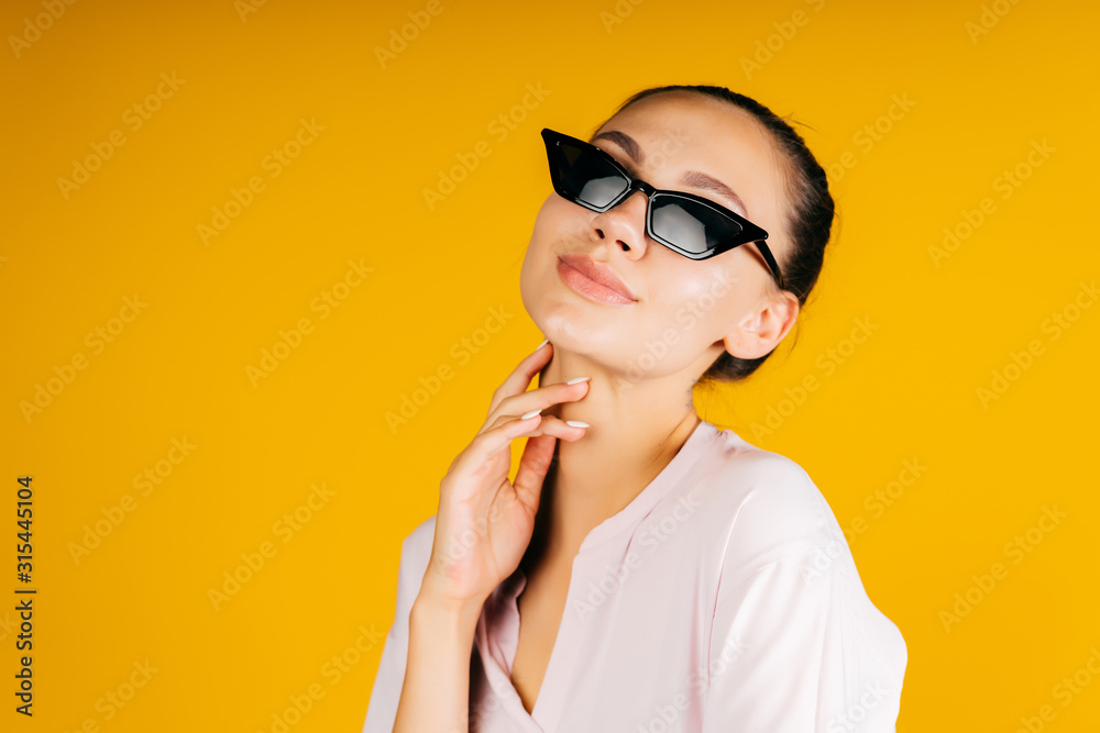 shyly smiling and gently touching her neck with her hand, the girl in ...