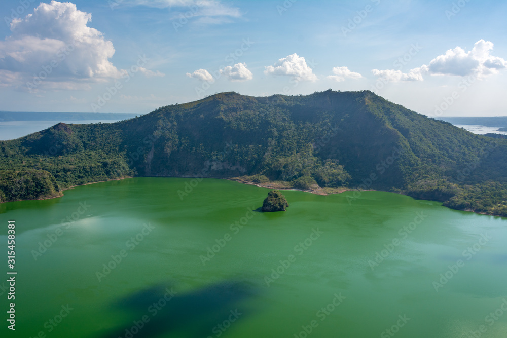 The lake in the crater of Taal volcano is located on the island of Luzon south of the capital of ...