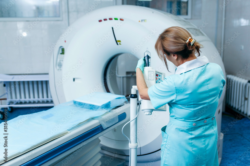 Doctor prepares automatic dual shot syringe for high tech ct scanner ...