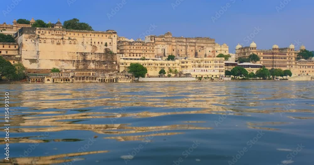 Udaipur City Palace on lake Pichola with tourist boat - Rajput ...