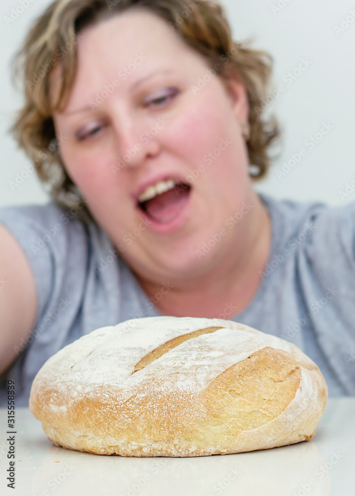 Fat girl eating bread. Hunger. Eating. Overweight woman eating a bun ...