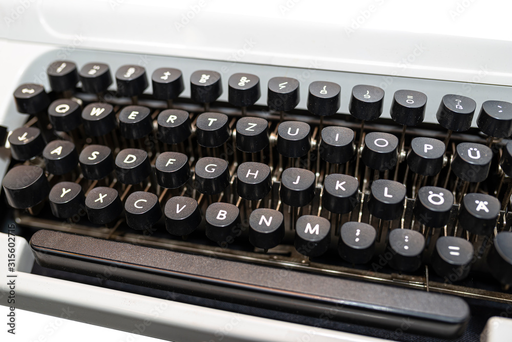 Classic, manual typewriter in white with a German keyboard layout ...