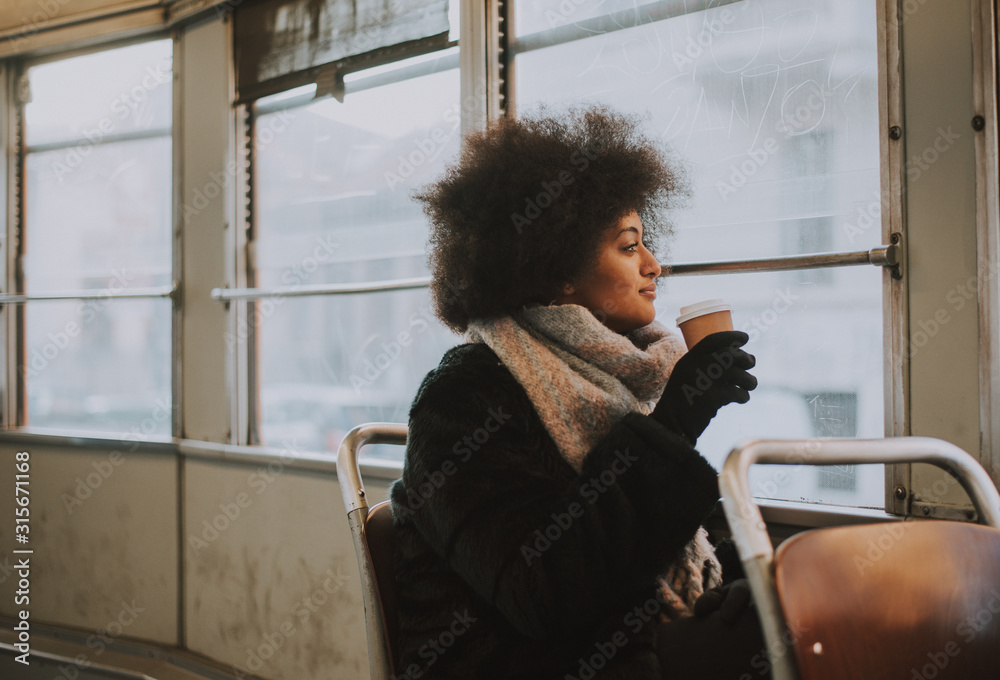 Beautiful girl with afro haircut portraits in the public transport ...