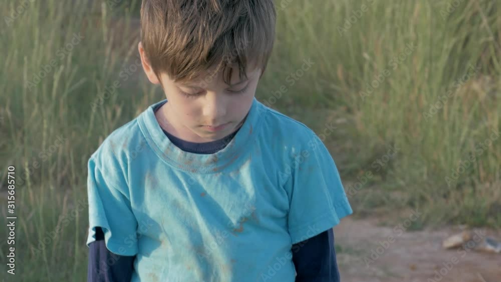 portrait little boy from the slums lowered his head resentfully stood ...