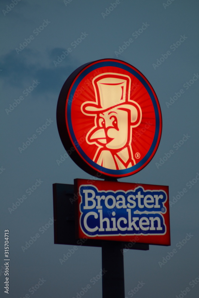 Broaster Chicken restaurant big logo at night Stock Photo | Adobe Stock