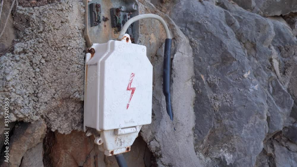 Outdoor electrical cable, leading to old junction box with lightning ...