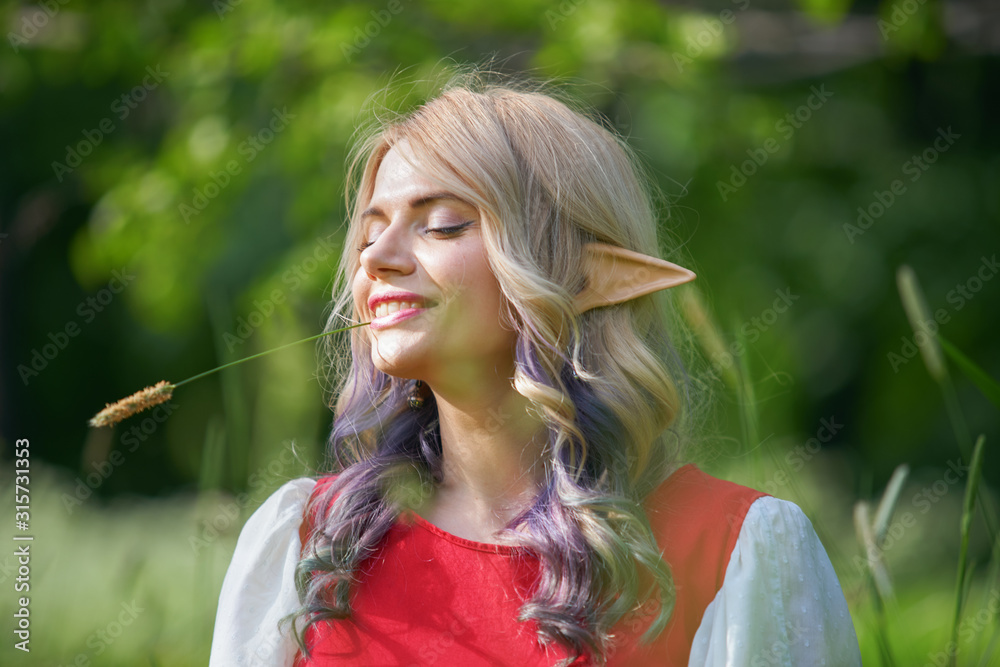 beautiful elf girl in nature. portraits of summer on a background of ...