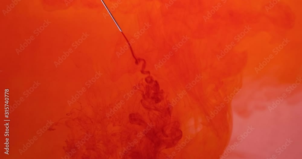 Needle injecting blood into water at white background. Inky red cloud ...