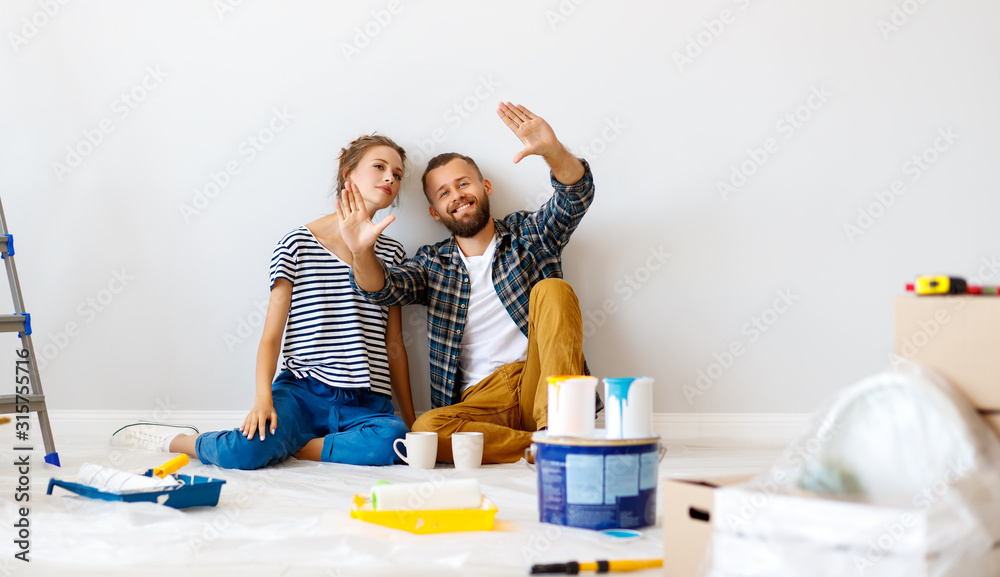 young happy family married couple dreams of renovating house and ...