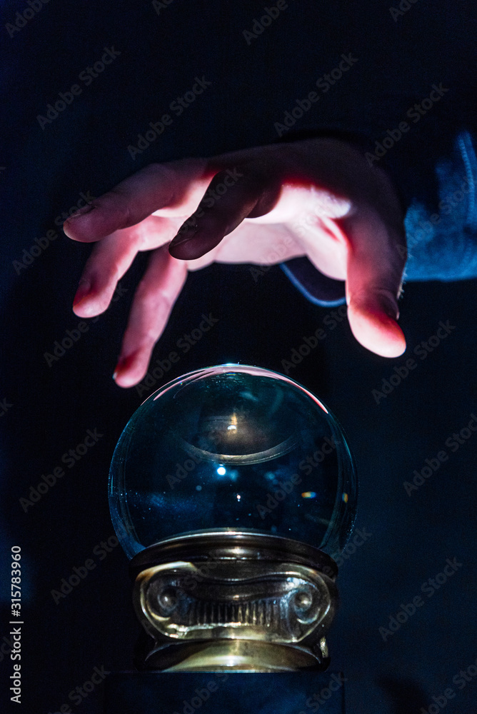 Hand over crystal ball in dark room, crystal ball gazing, crystal ball ...