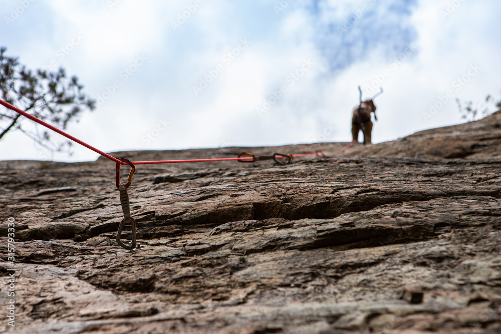 Worms eye perspective from the bottom of a sheer crag, a blurry rock ...