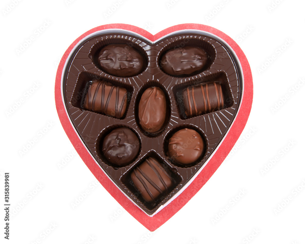 Heart shaped box with chocolate candies isolated on white background. A ...