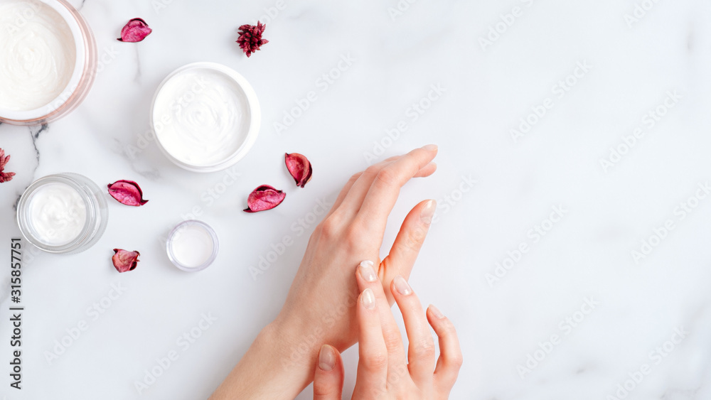 Hand skin care concept. Top view female hands applying organic ...