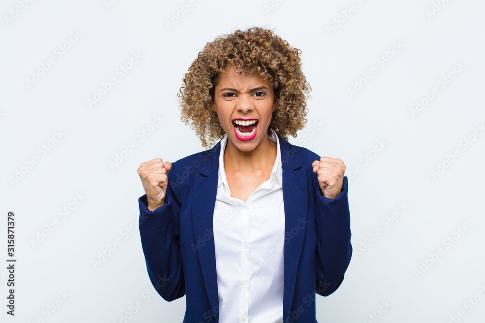 young woman african american shouting aggressively with an angry ...