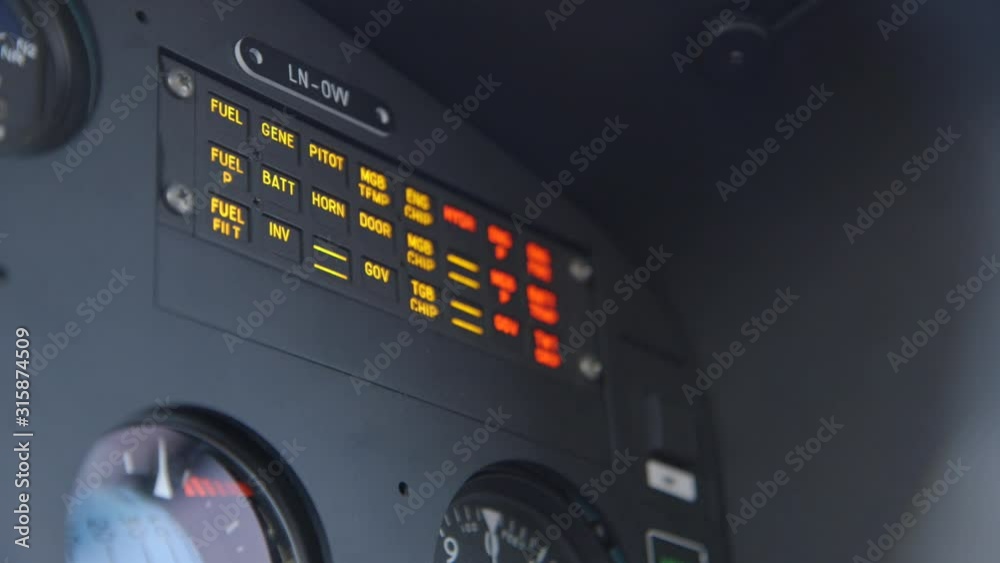 Inside cockpit of helicopter instruments - warning lights lighting up ...