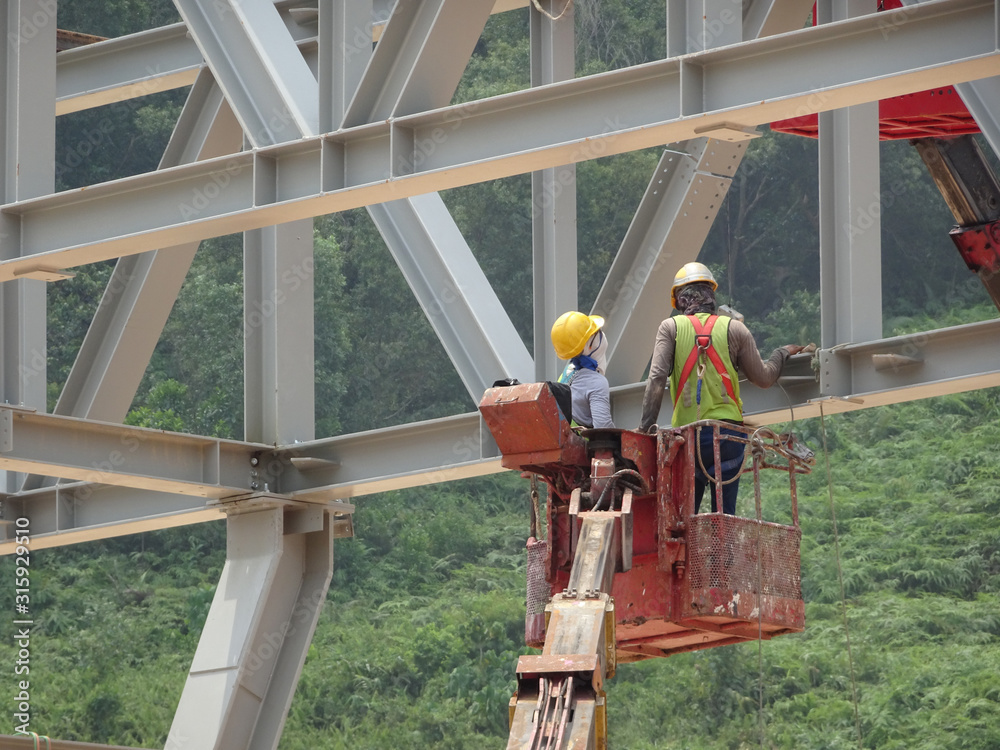 Construction workers working at height installing the steel structure ...