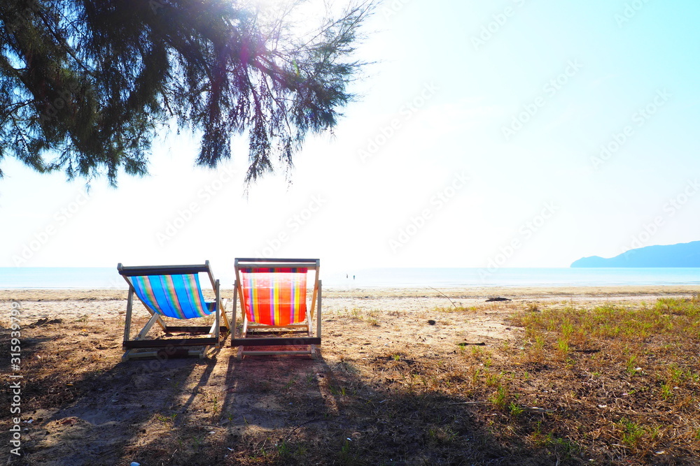 Two wooden folding beach chairs and beautiful blue sea view with ...