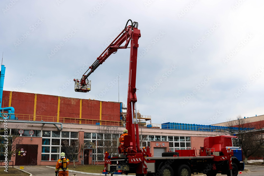 Firefighter rescuers at work in fireproof suits came to extinguish a ...