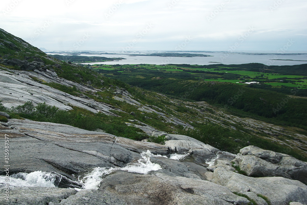 View to the mountain creek running down by grey granite cliffs of Seven ...